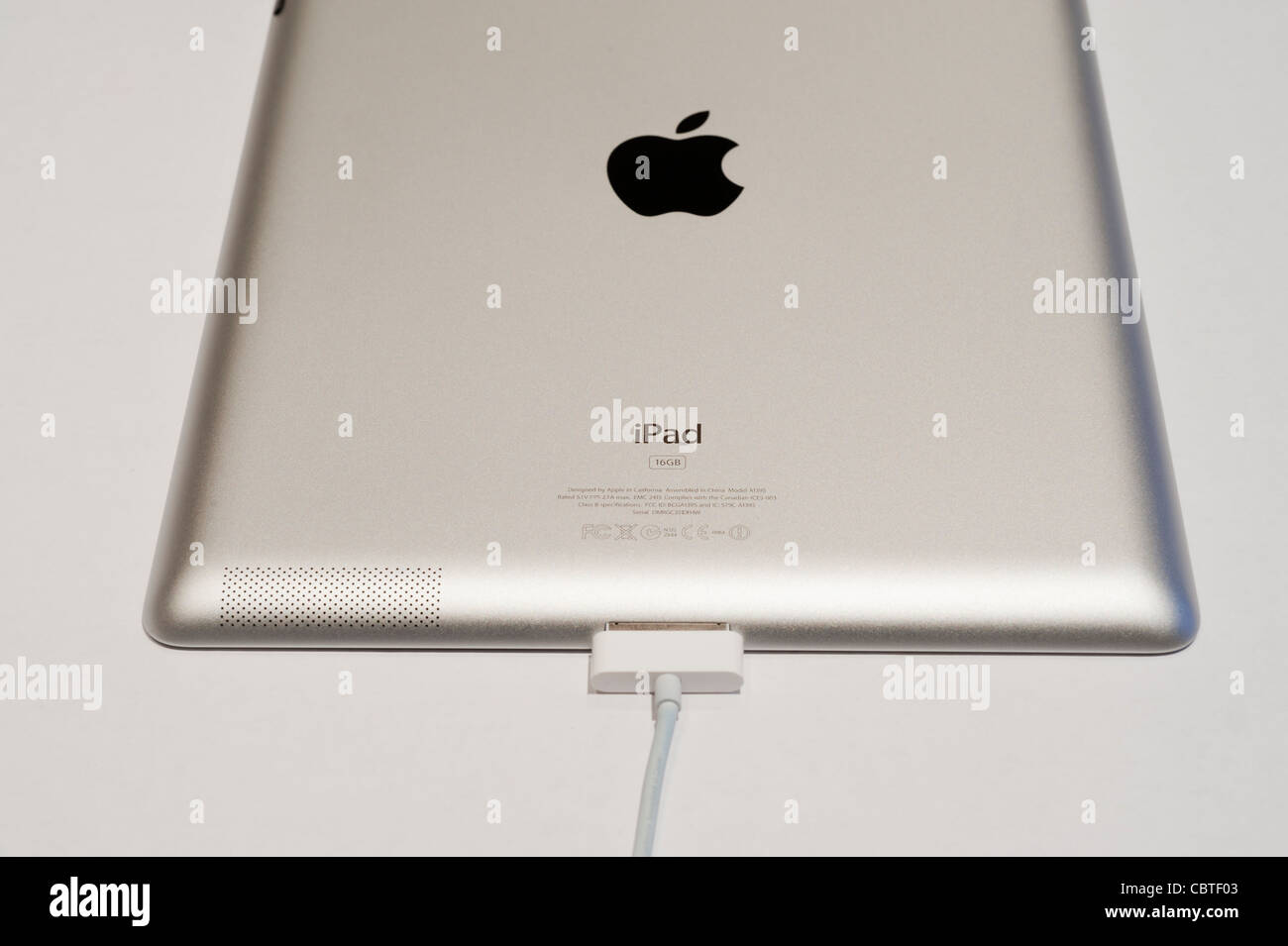 The iPad 2 plugged in with power cable Stock Photo - Alamy