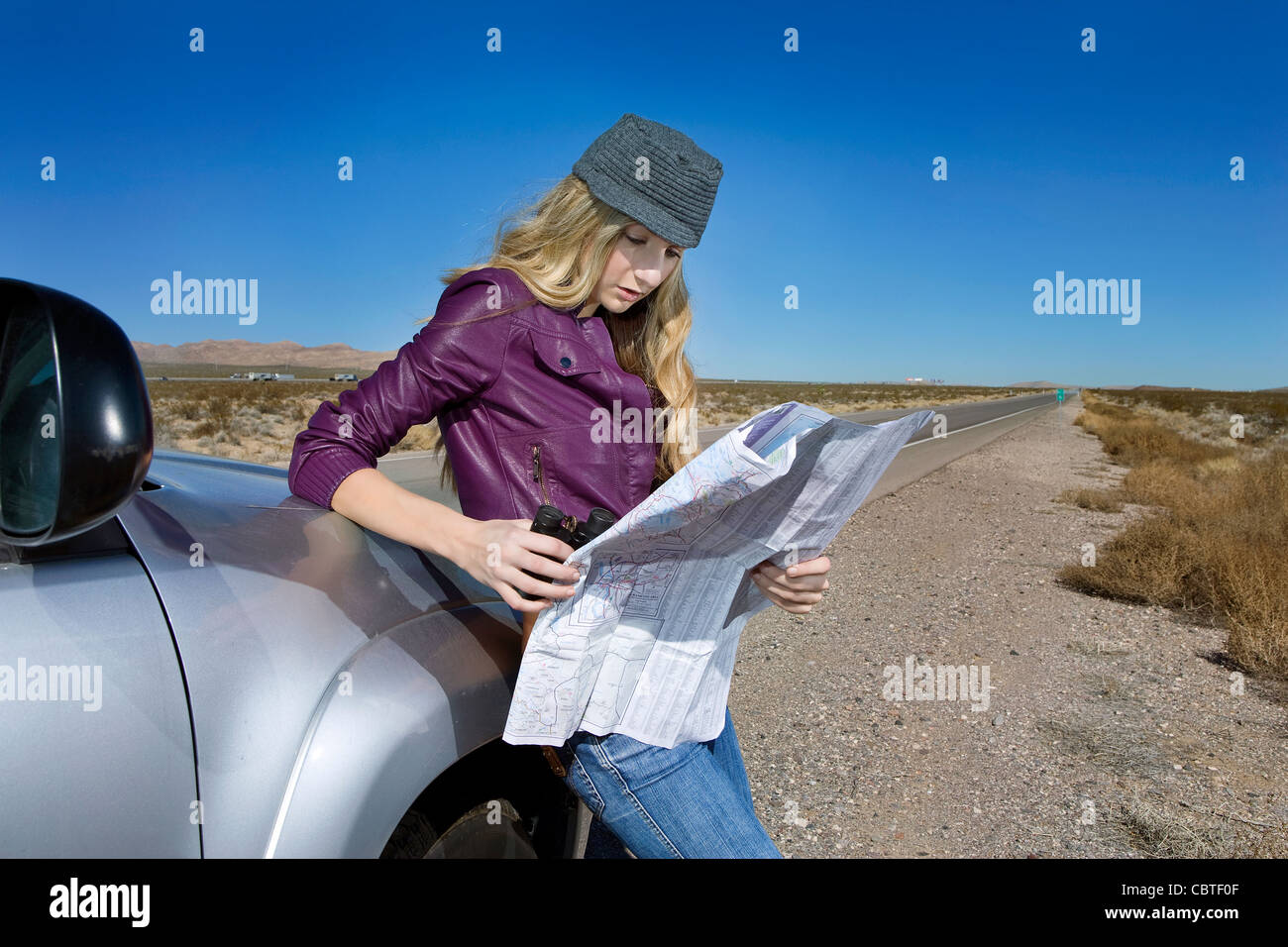 Caucasian woman reading map at roadside Stock Photo - Alamy