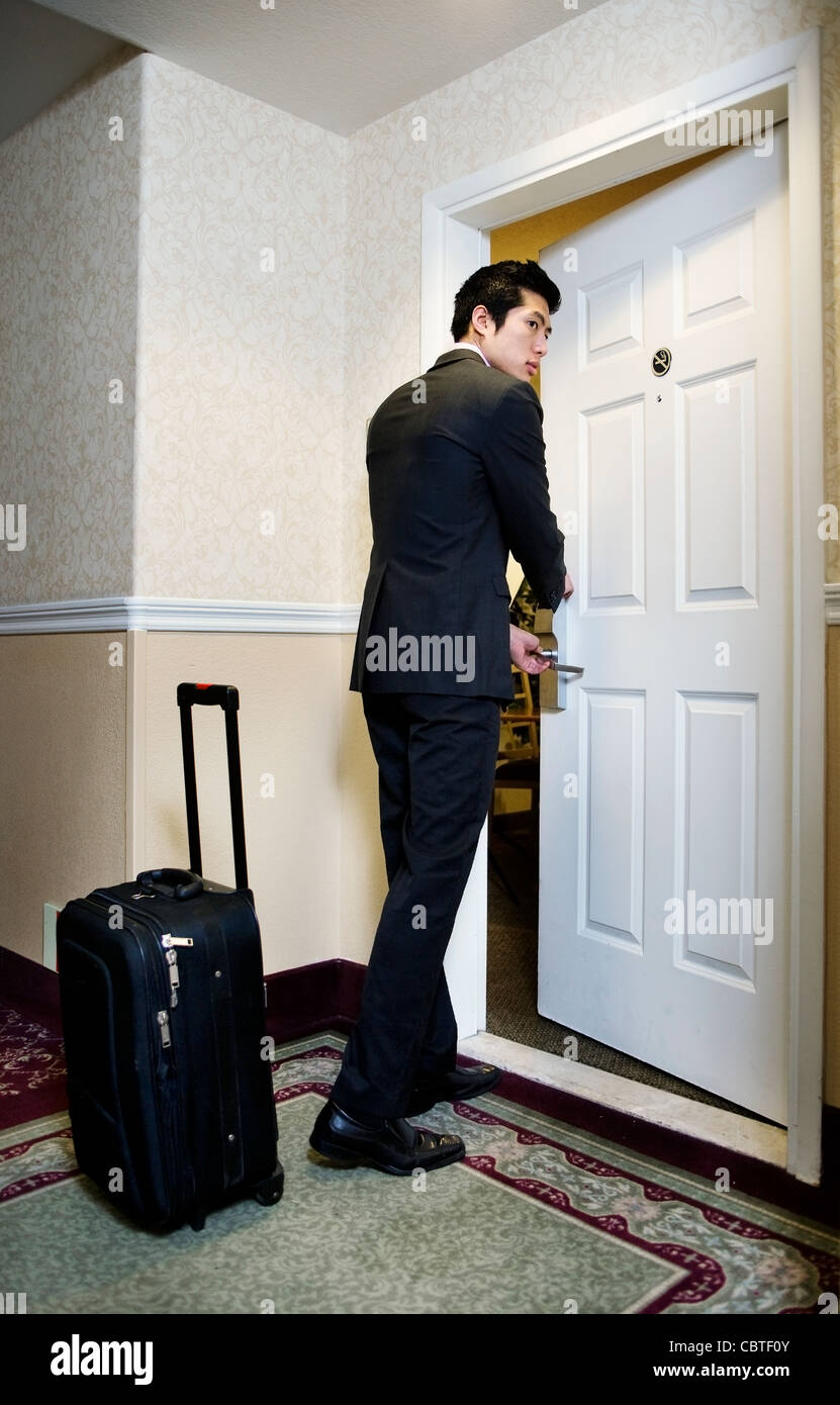Asian businessman entering hotel room Stock Photo - Alamy