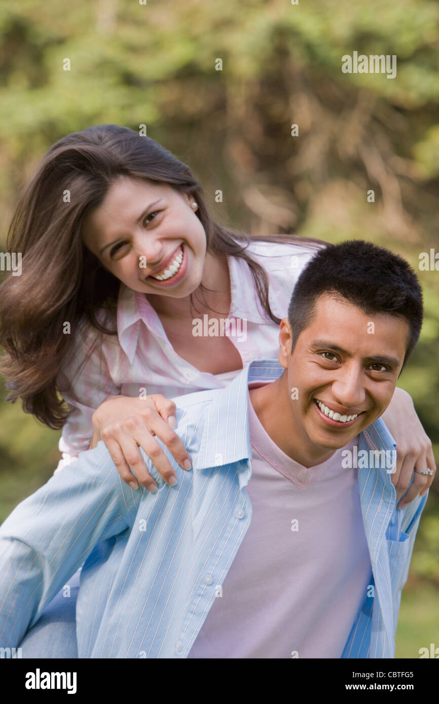 Hispanic man giving wife piggyback ride Stock Photo - Alamy
