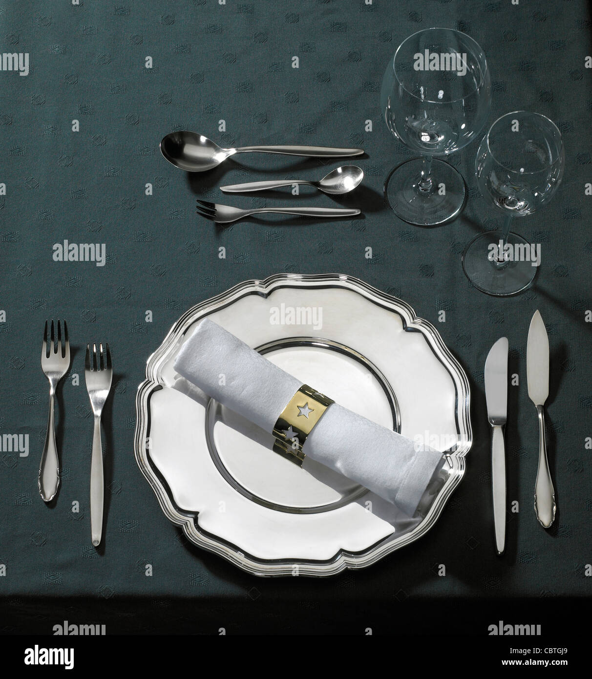 classy place setting with flatware and drinking glasses seen from above ...