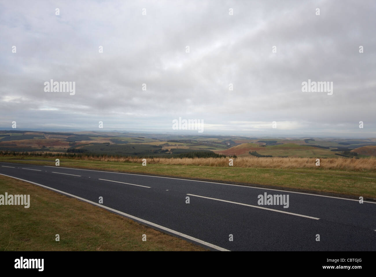 panoramic view with road in Scotland in front of clouded sky Stock ...