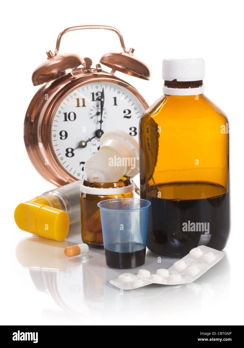 Alarm clock and medicine on white background Stock Photo - Alamy