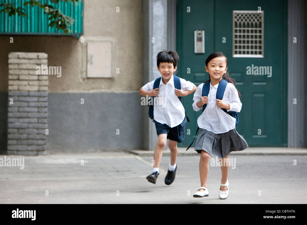 Children running to school Stock Photo - Alamy
