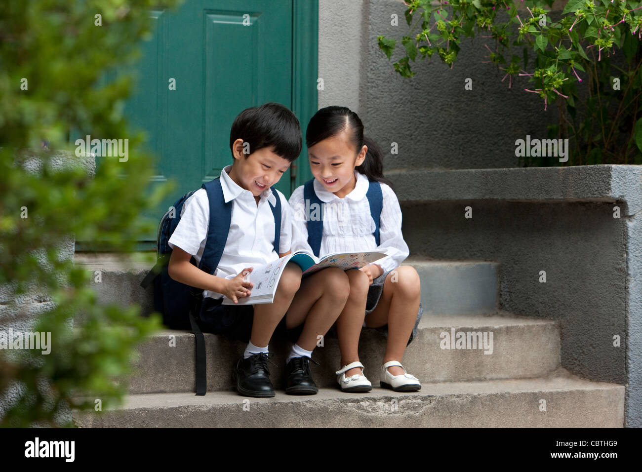 Two school children studying outside Stock Photo - Alamy