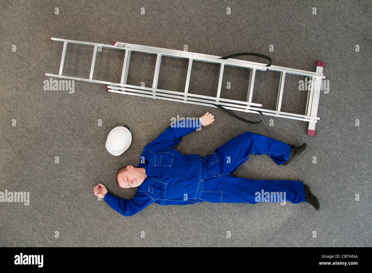 worker fell from a ladder and lies on the floor Stock Photo - Alamy