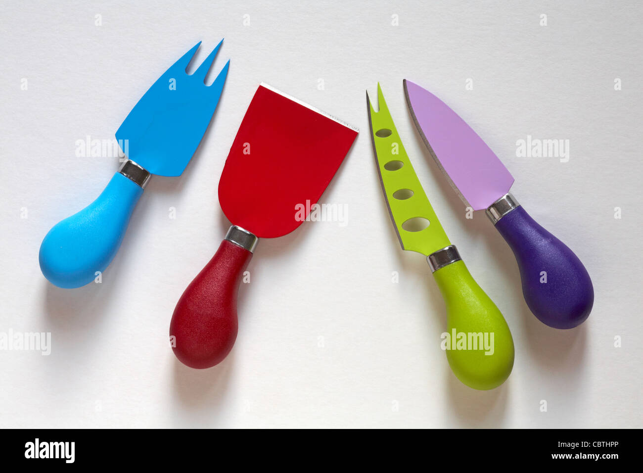 set of colourful cheese knives isolated on white background Stock Photo ...