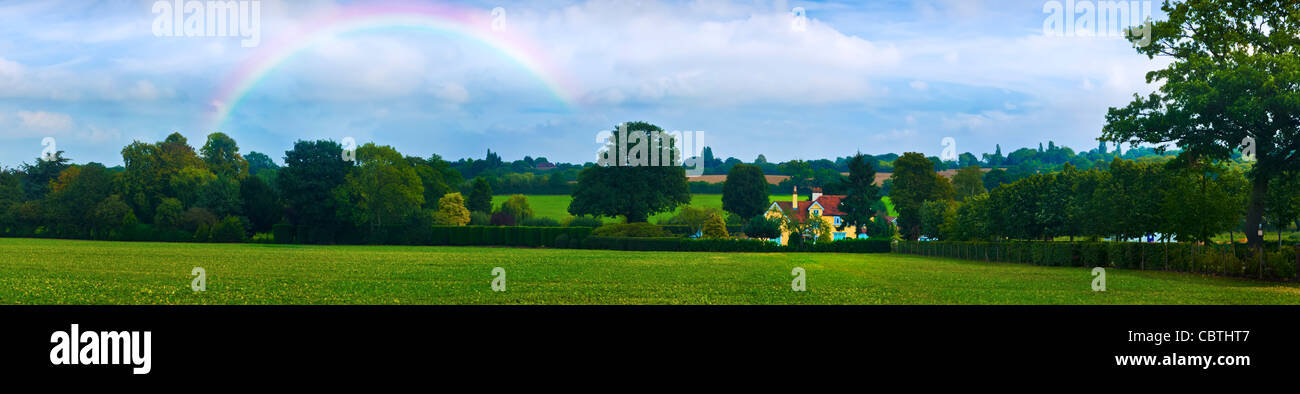 panoramic view of country scene with rainbow Stock Photo - Alamy