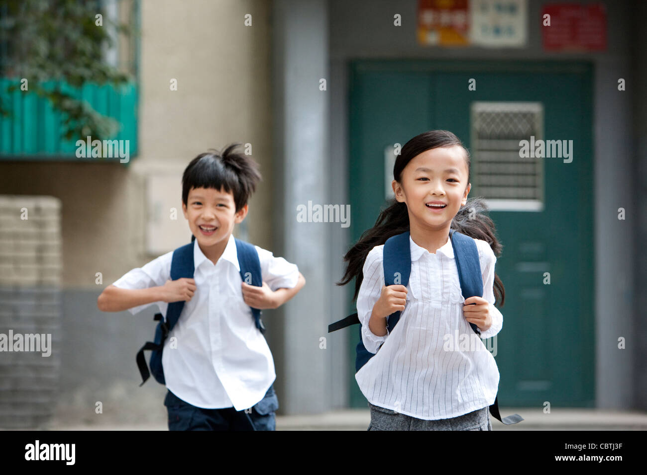 Children running to school Stock Photo - Alamy