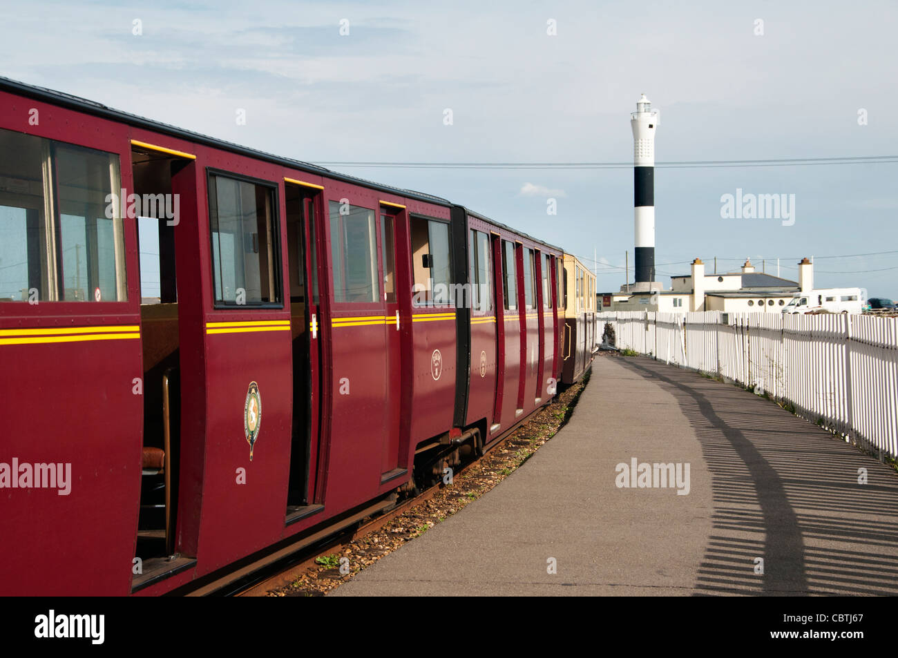 Romney, Hythe and Dymchurch Railway train with the lighthouse in the ...
