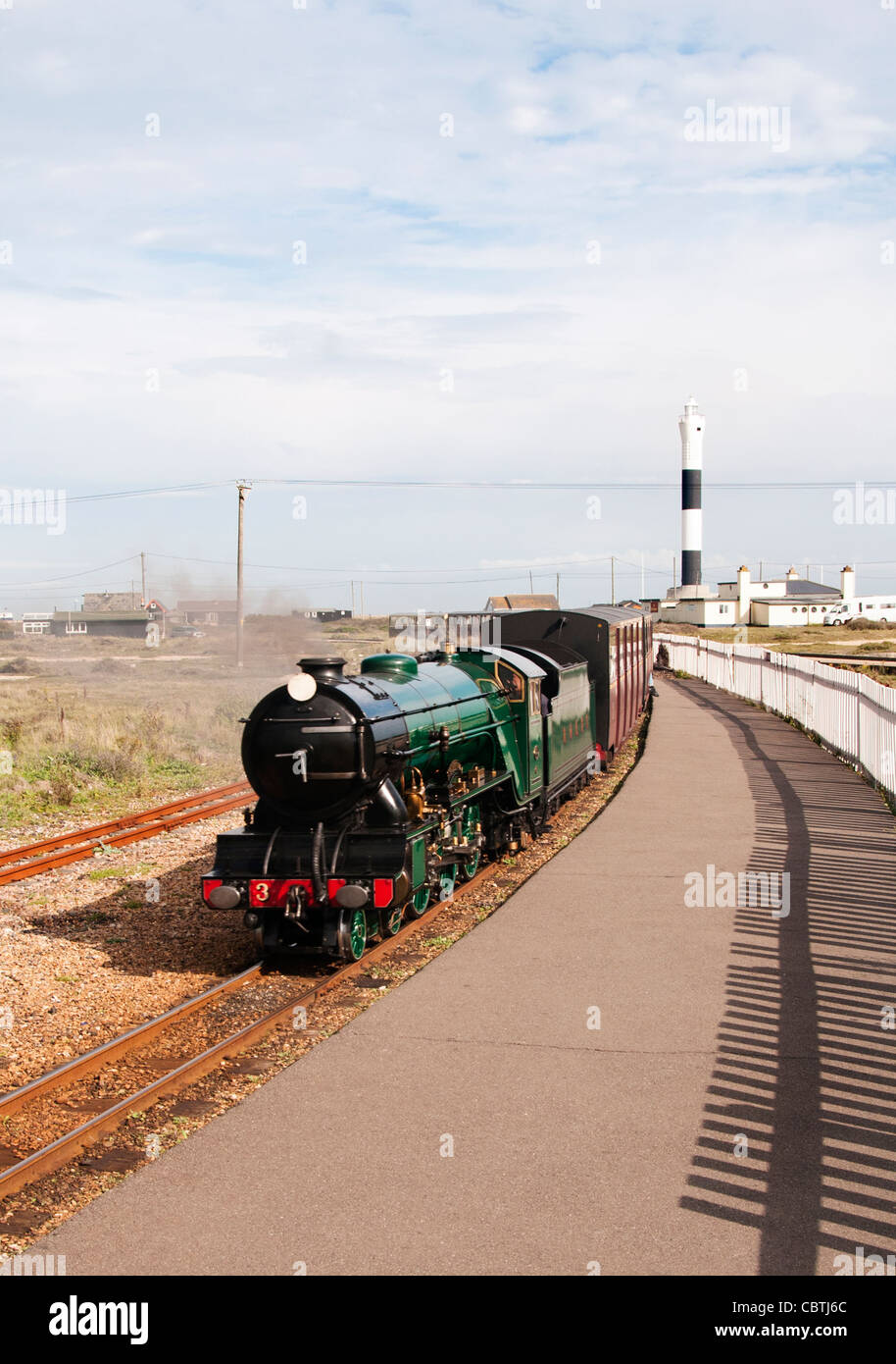 Romney, Hythe and Dymchurch Railway train with the lighthouse in the ...
