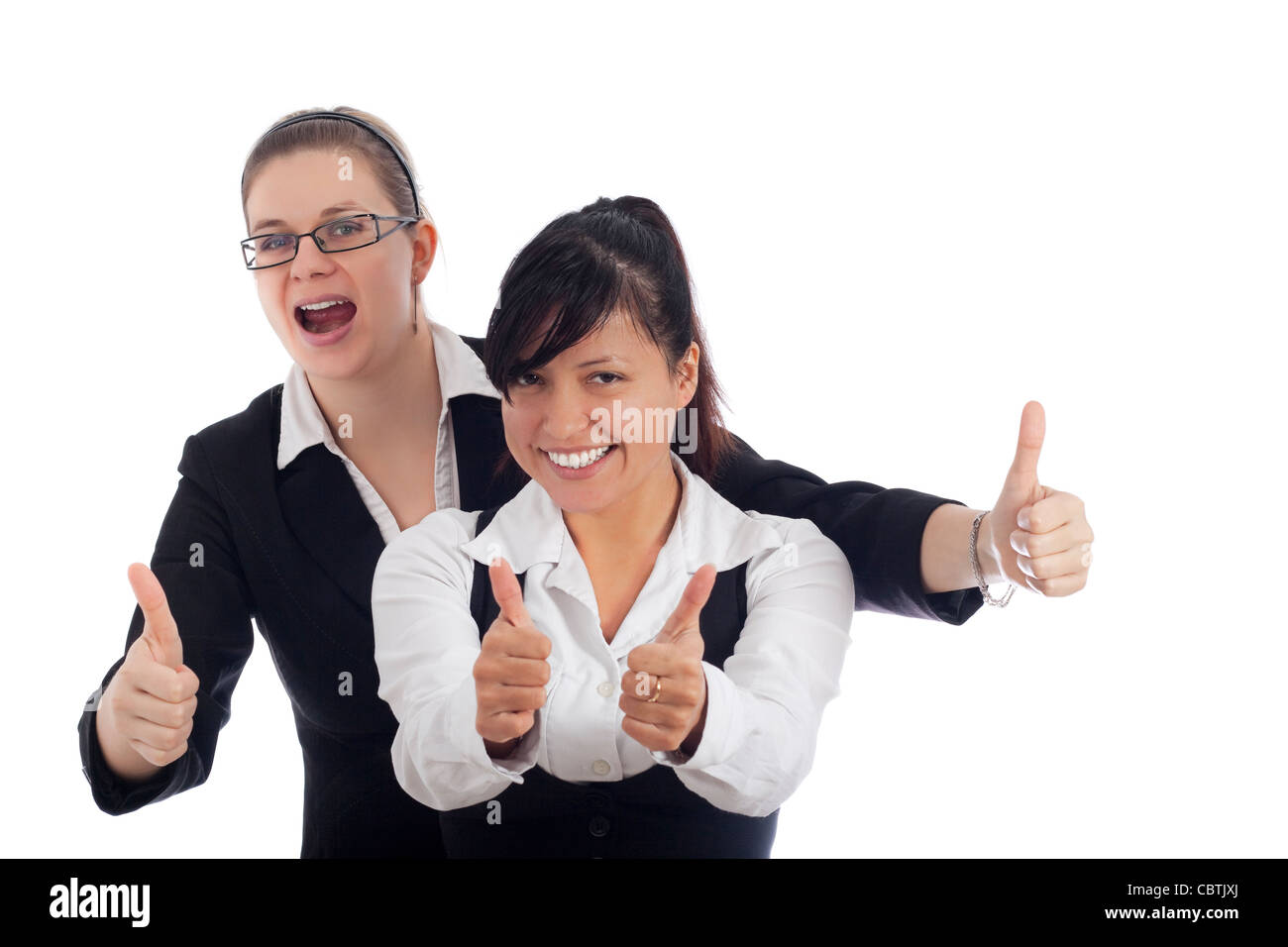 Two young successful business women gesturing thumbs up, isolated on ...