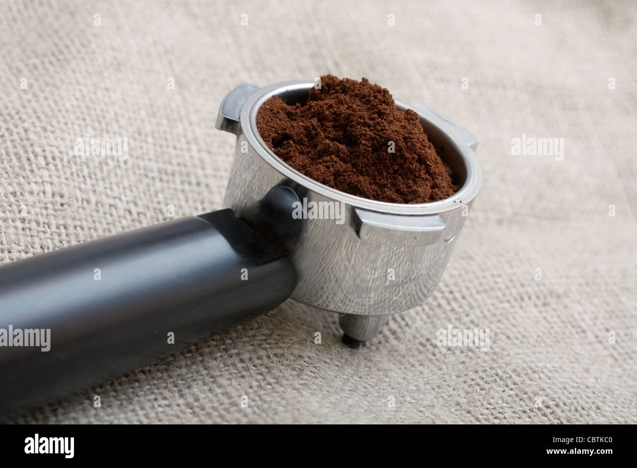 An espresso handle filled with ground coffee Stock Photo - Alamy