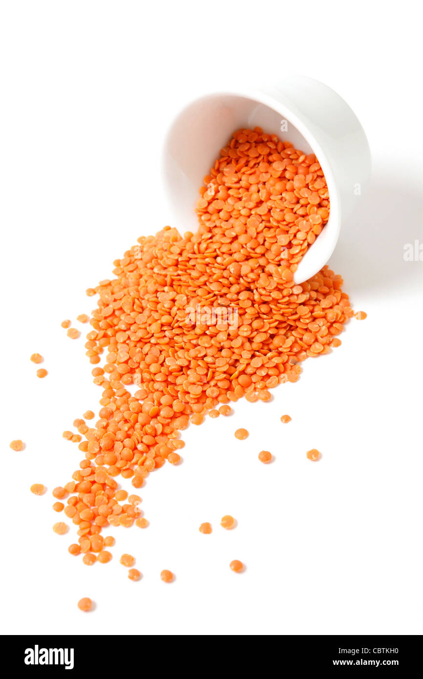 Red lentils on a white bg Stock Photo - Alamy