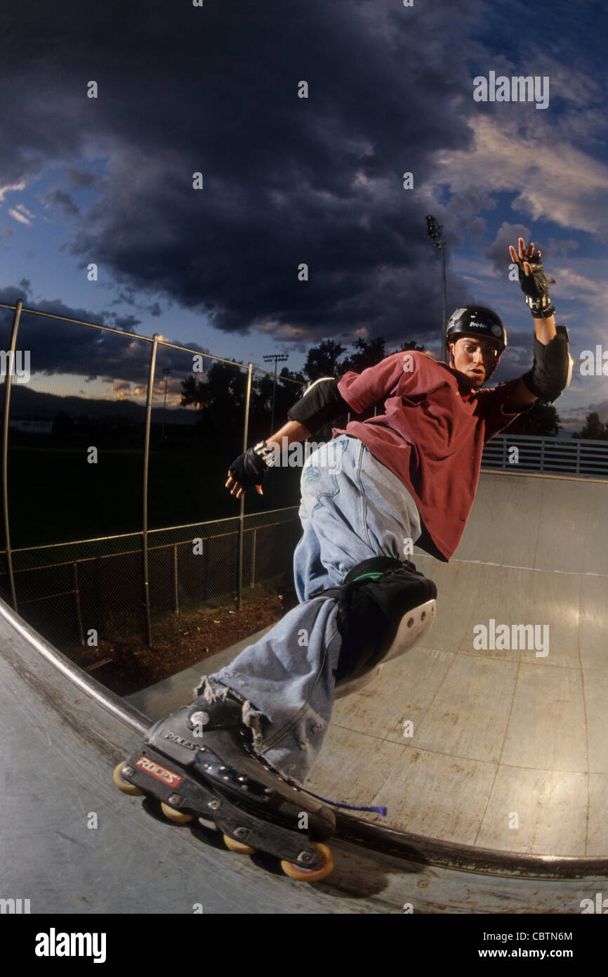Teenage boy inline skating on the vert ramp Stock Photo - Alamy