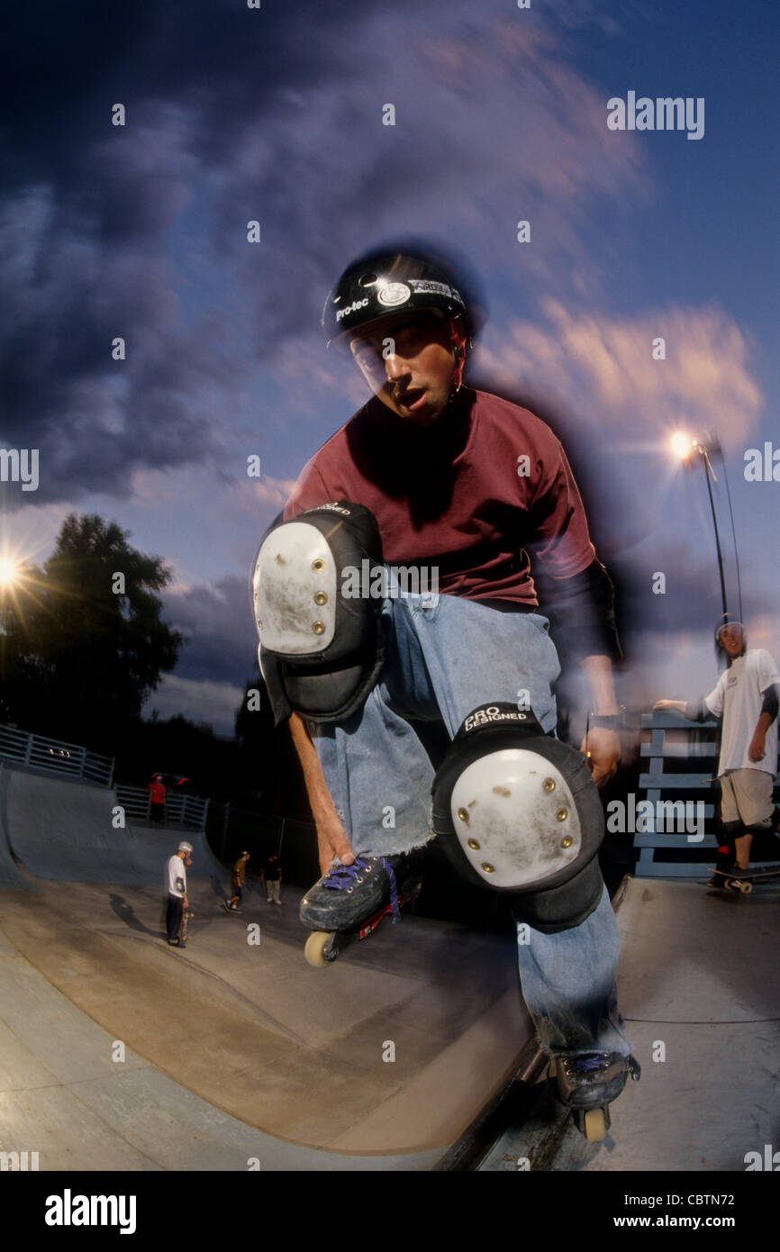 Teenage boy inline skating on the vert ramp Stock Photo - Alamy