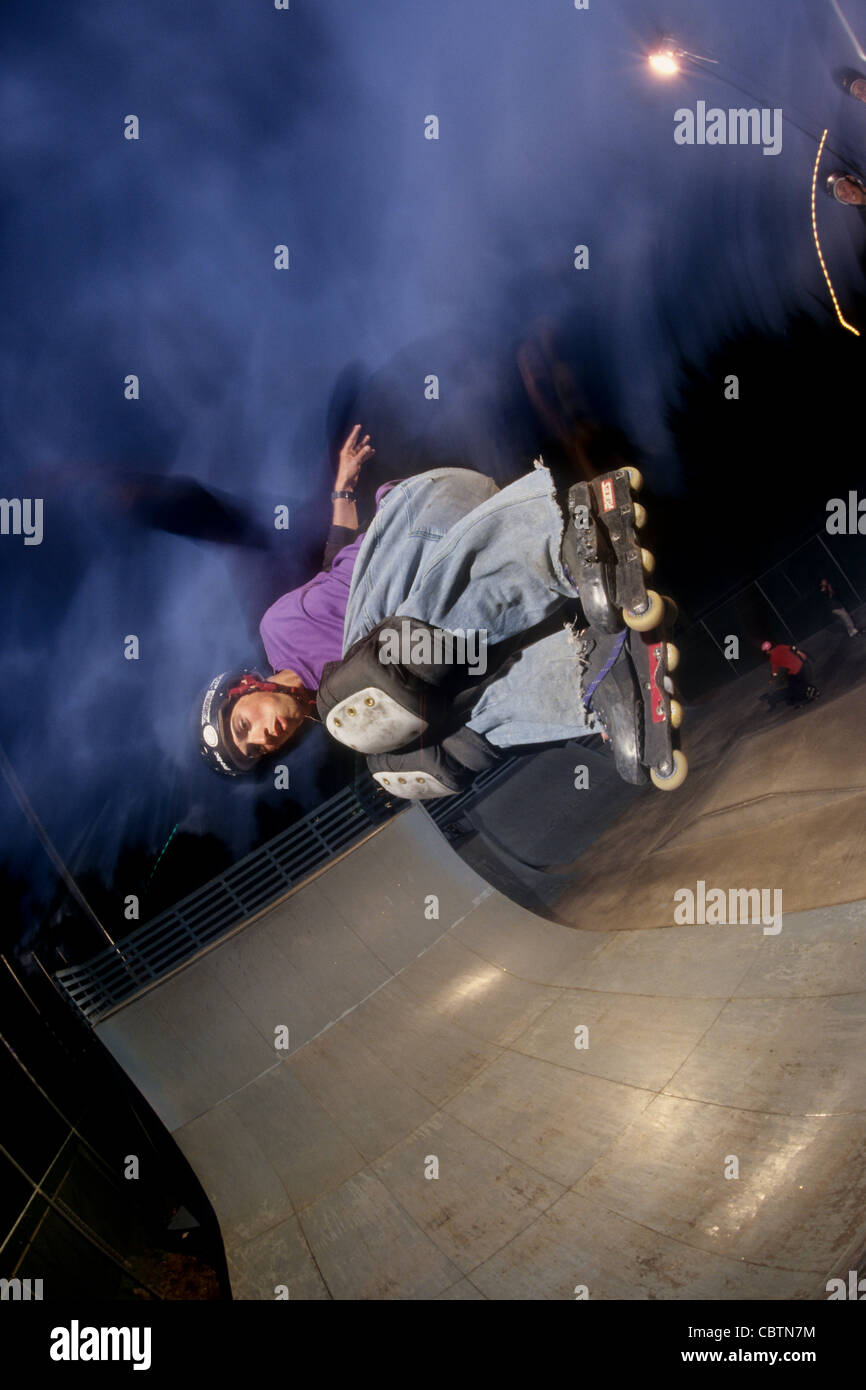 Teenage boy inline skating on the vert ramp Stock Photo - Alamy