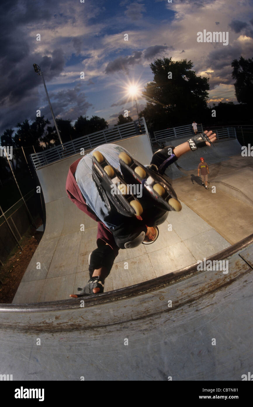 Teenage boy inline skating on the vert ramp Stock Photo - Alamy