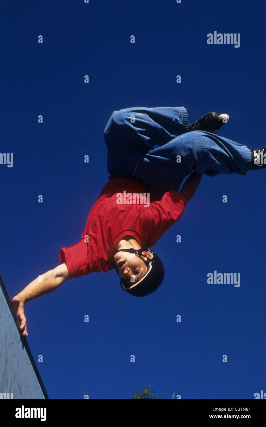 Teenage boy inline skating on the vert ramp Stock Photo - Alamy