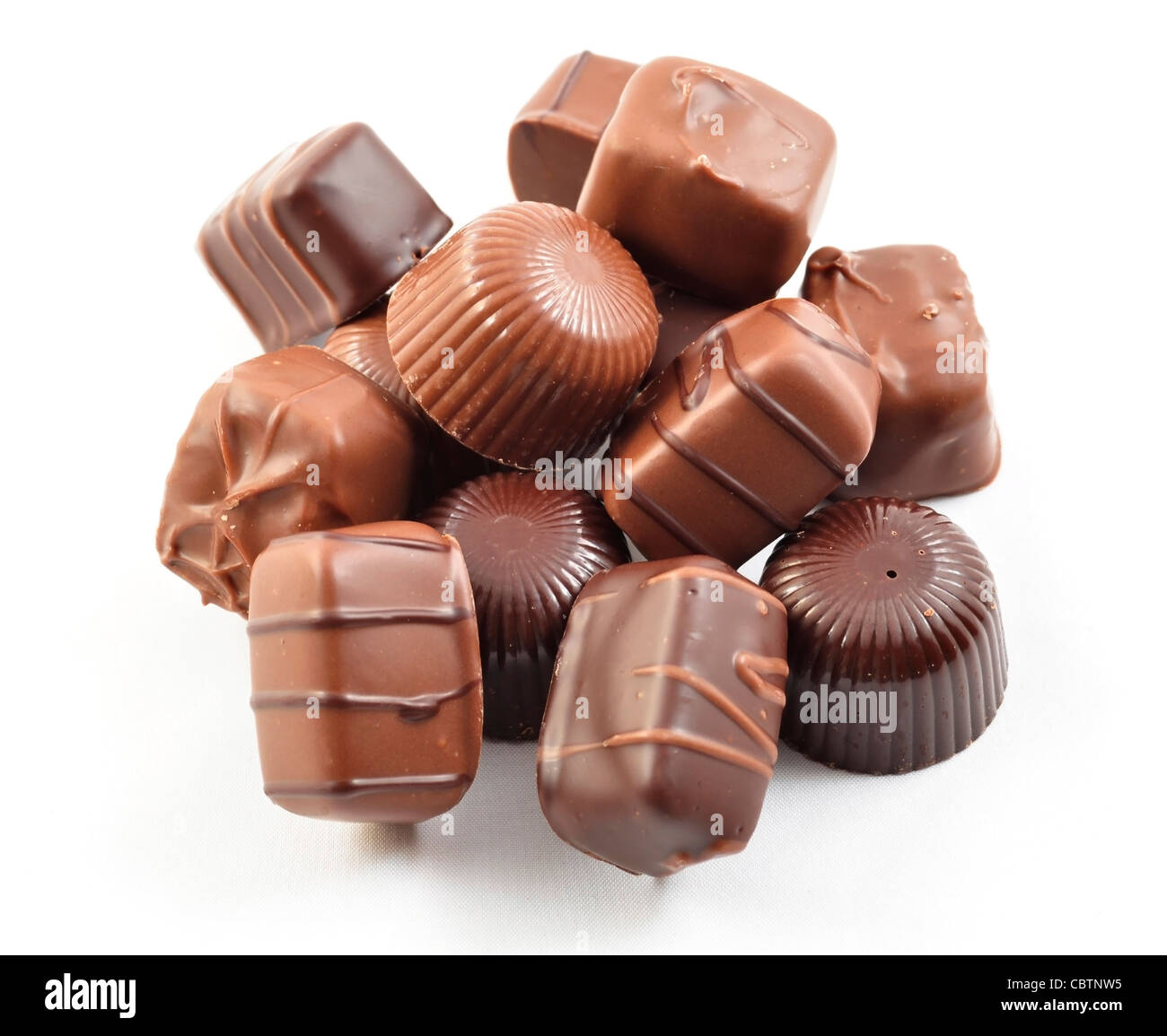 a stack of chocolate candies on white background Stock Photo - Alamy