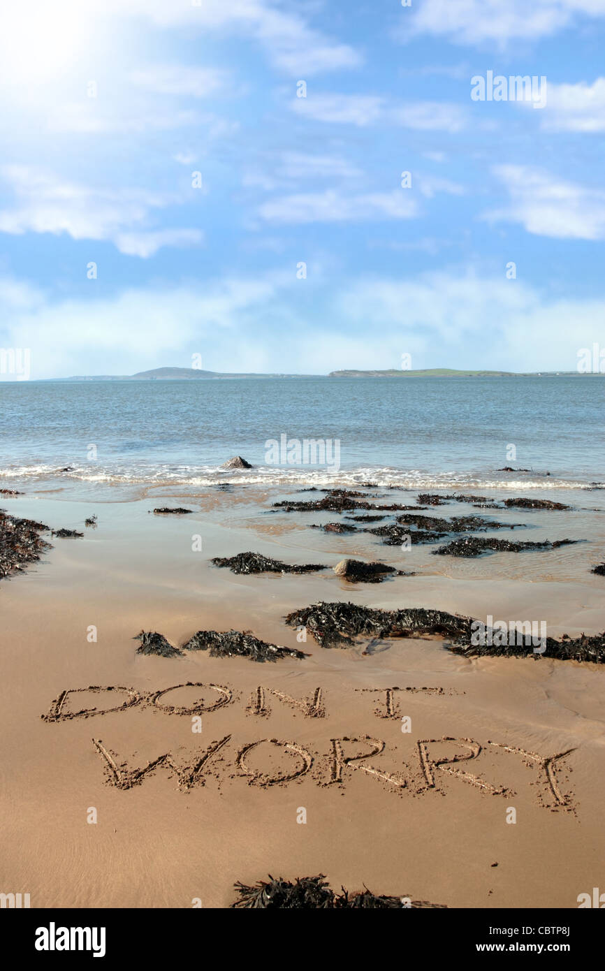 don't worry inscribed on the beach with waves in the background on a ...
