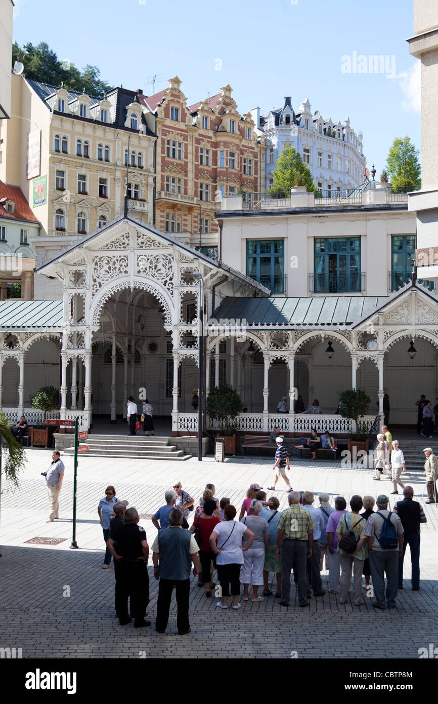 Guided group of tourists in front of the market colonnade and beautiful ...