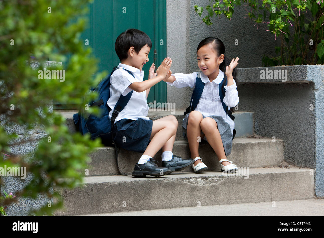 School children playing outside uniform hi-res stock photography and ...