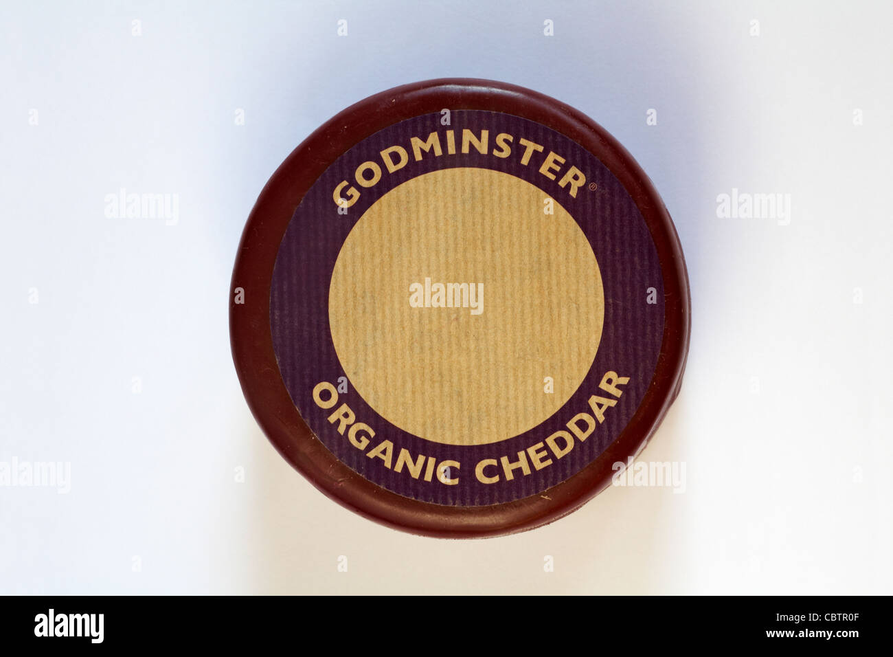 A round of Godminster Organic Cheddar Cheese isolated on white ...
