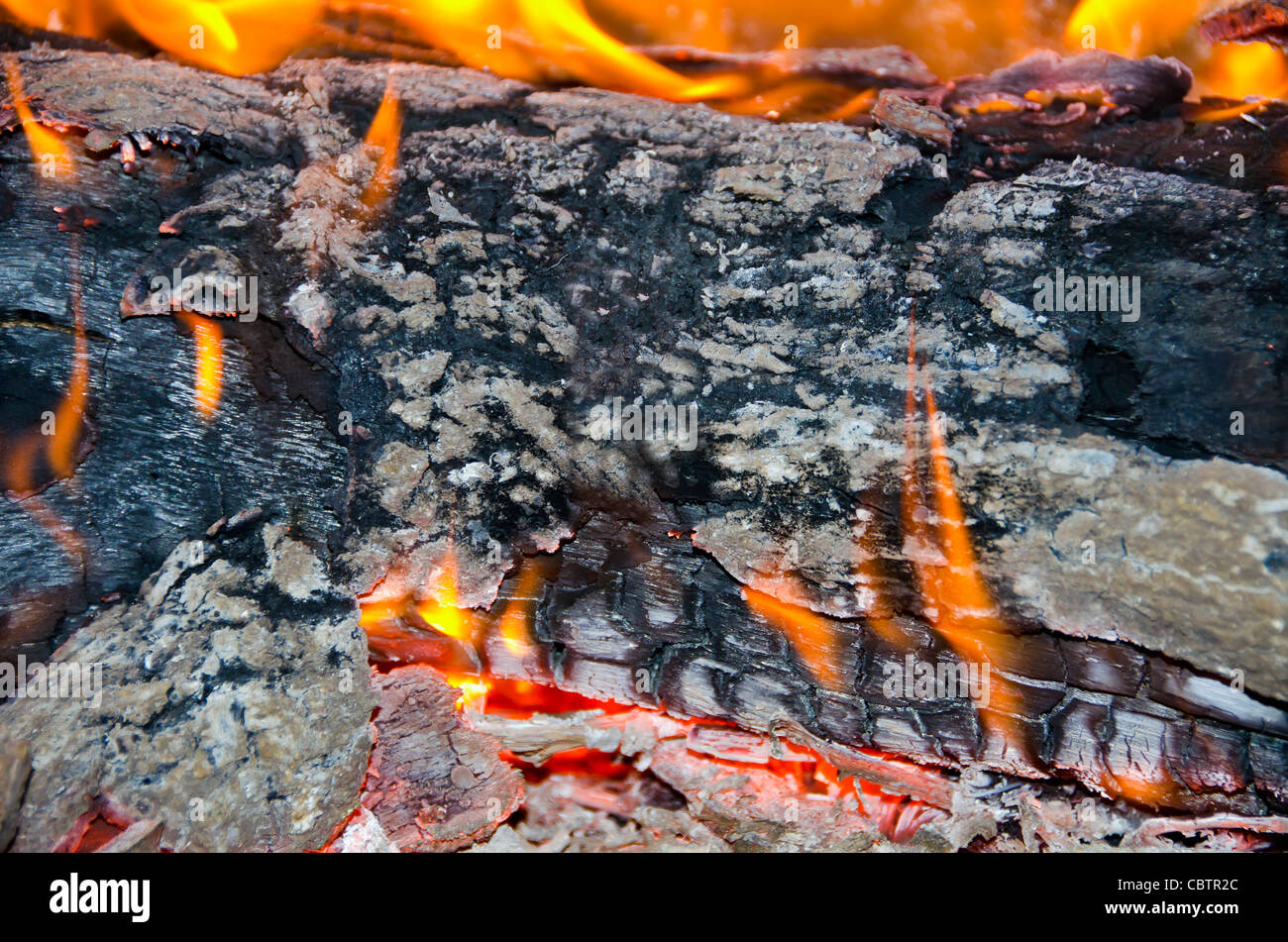 Log burning in wood stove fireplace with flames and coals Stock Photo ...