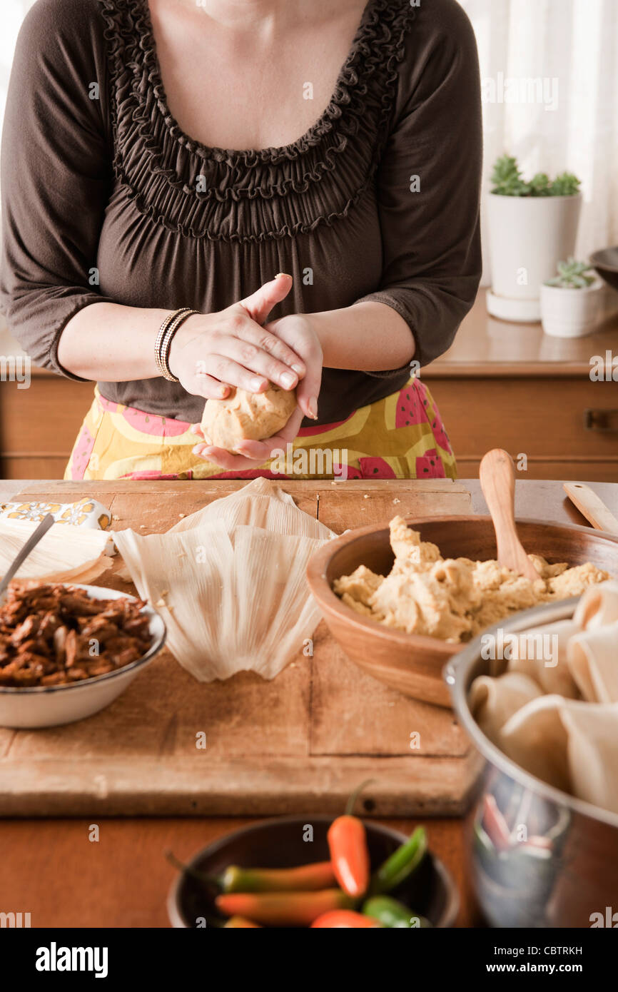 Woman making tamales Stock Photo - Alamy