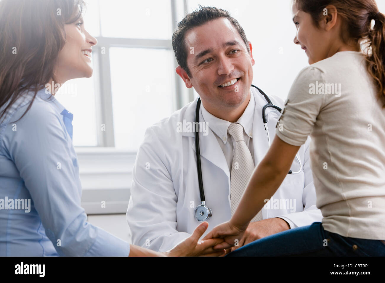 Doctor talking to patient family ethnic hi-res stock photography and ...