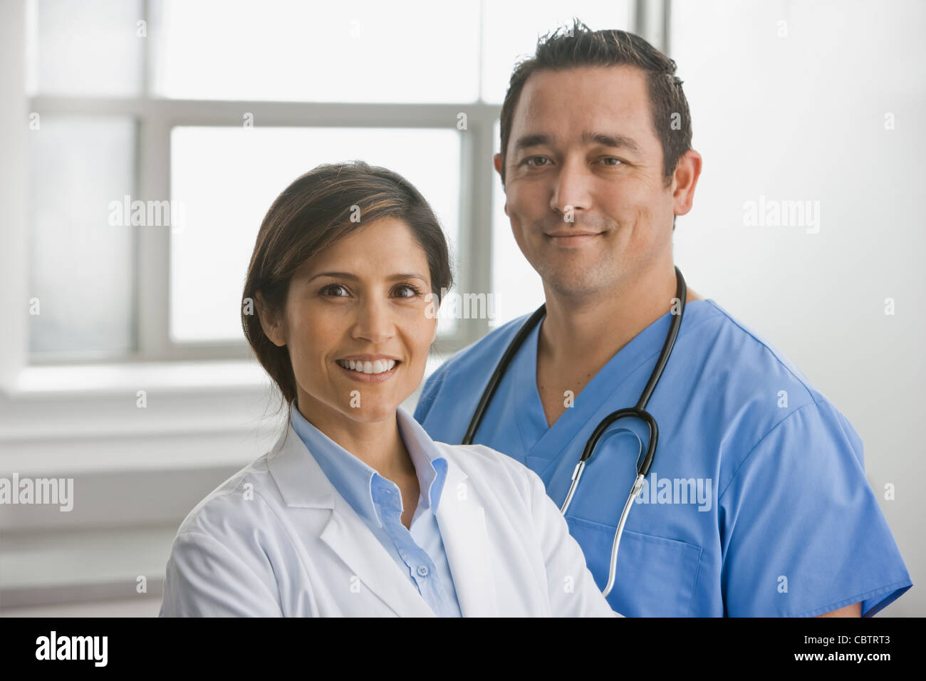 Smiling doctors standing together Stock Photo - Alamy