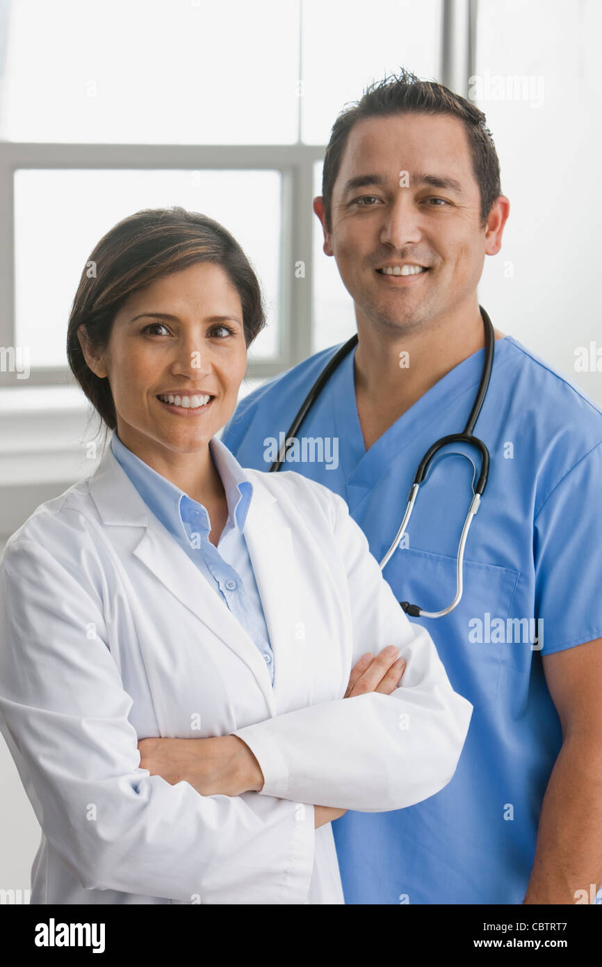 Smiling doctors standing together Stock Photo - Alamy