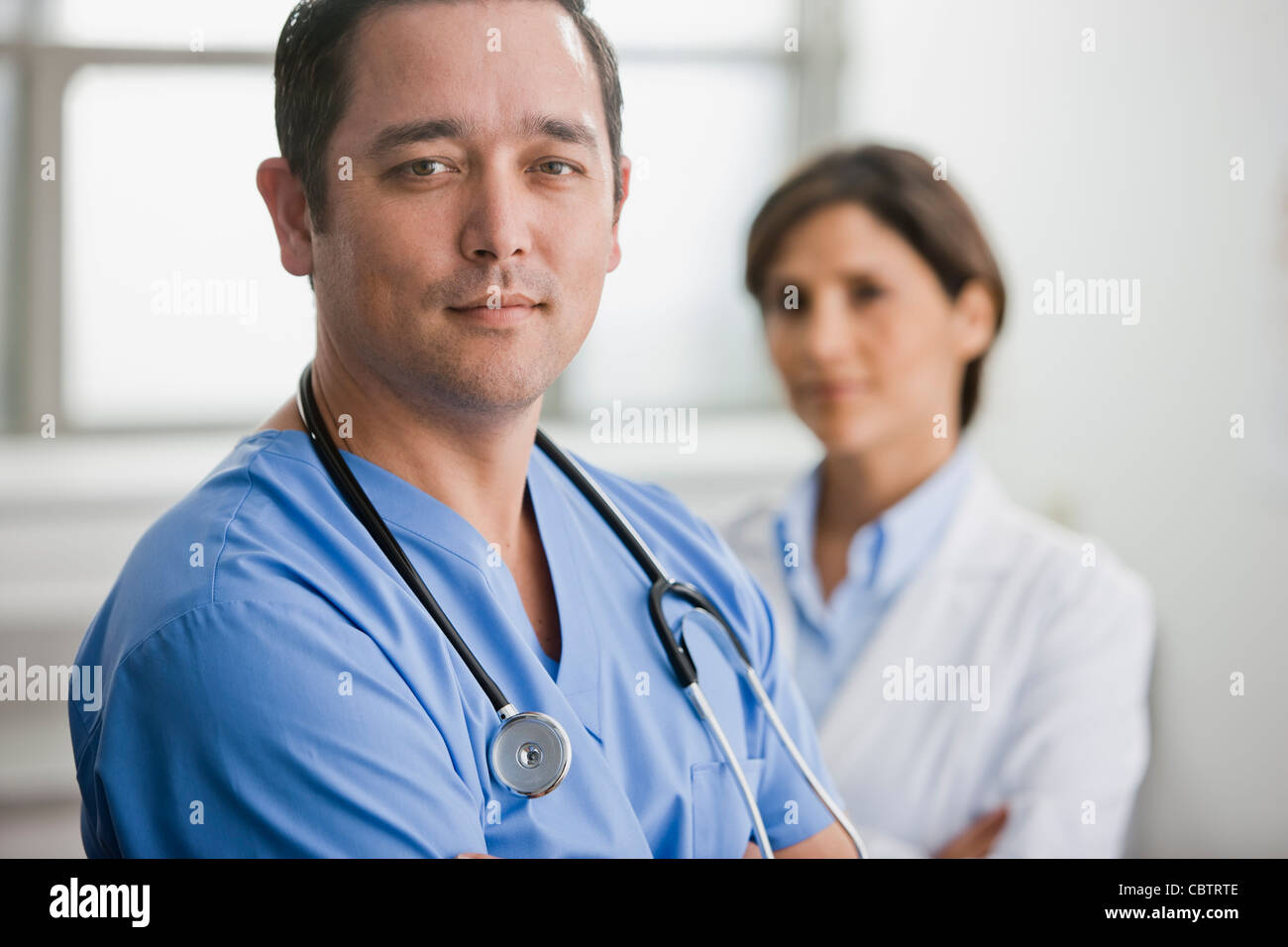 Smiling doctors standing together Stock Photo - Alamy
