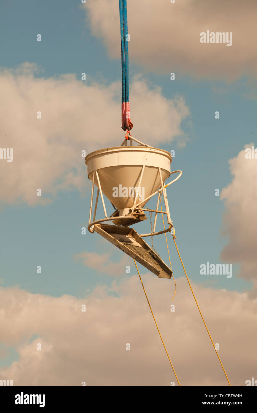 Cement bucket suspended from a tower crane Stock Photo - Alamy