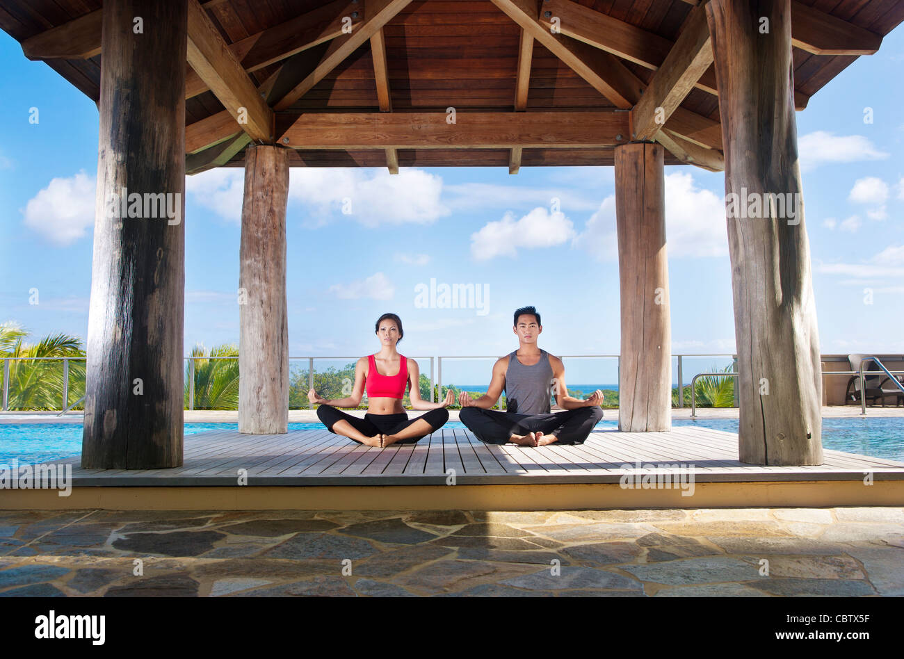 Couple practicing yoga together Stock Photo - Alamy