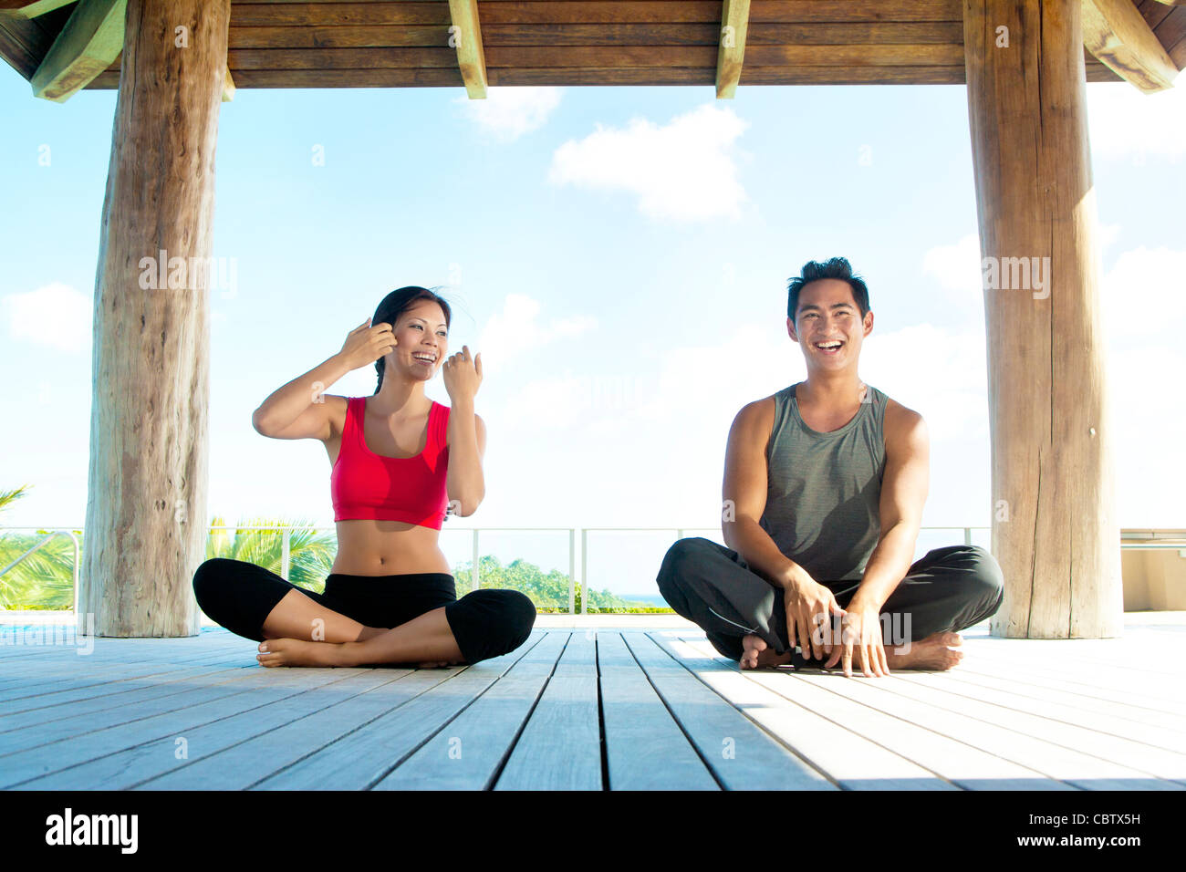 Couple practicing yoga together Stock Photo - Alamy