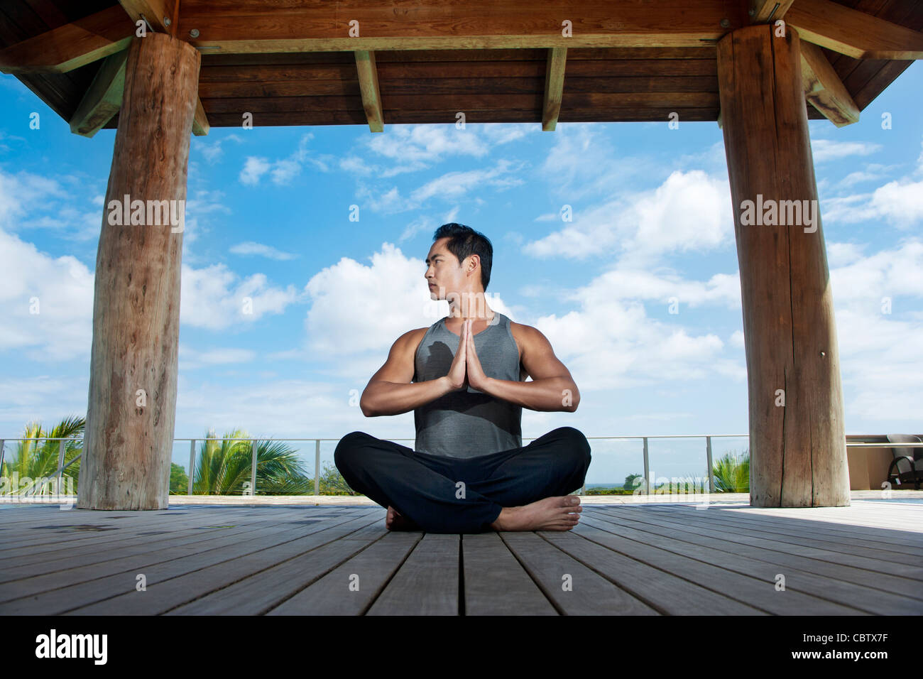 Asian man practicing yoga Stock Photo - Alamy