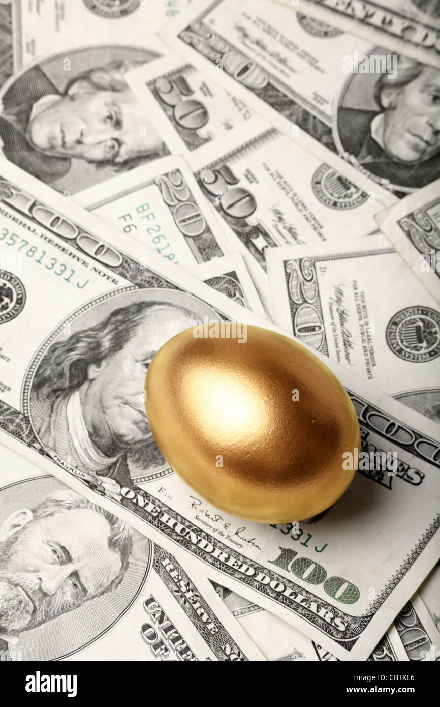 golden egg and dollars, concept of Making Money Stock Photo - Alamy