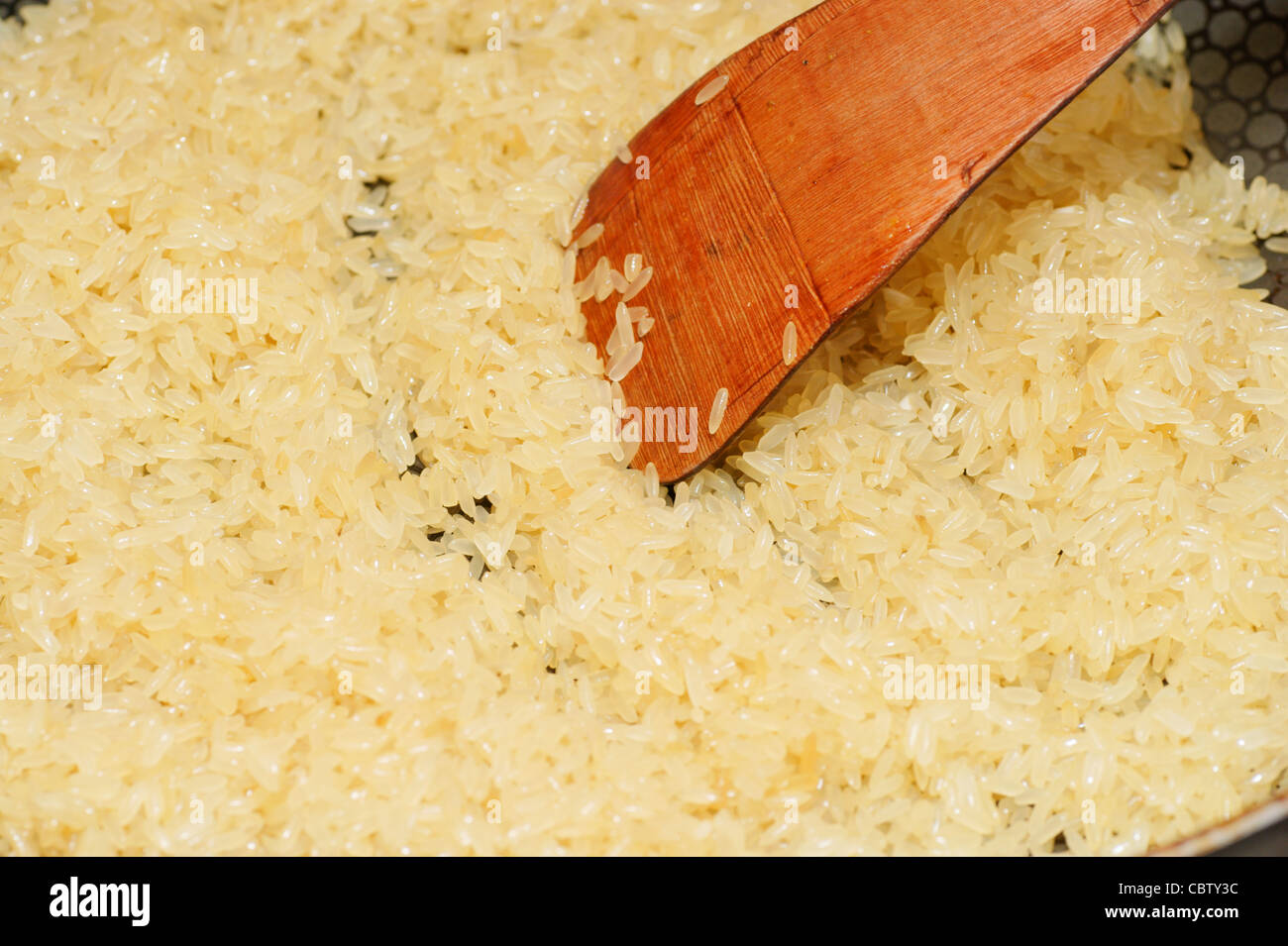 rice on frying pan, skillet, wood spoon Stock Photo - Alamy
