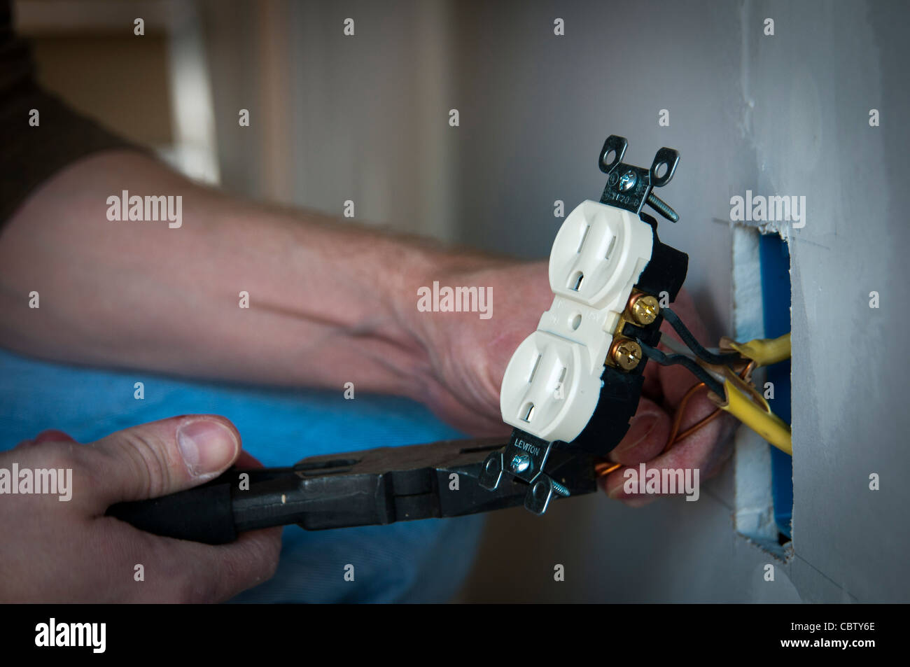 Electrician wiring an electrical receptacle wall socket Stock Photo - Alamy