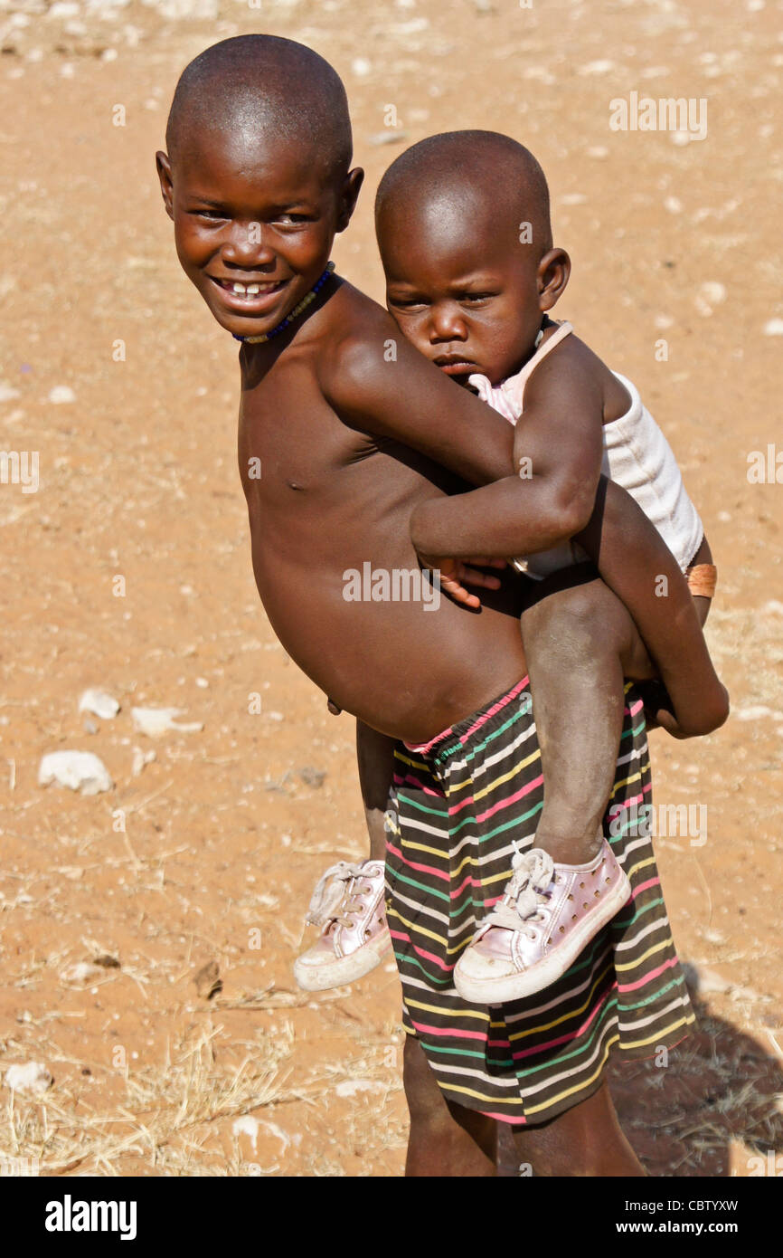 Herero boy carrying baby on back, Damaraland, Namibia Stock Photo - Alamy