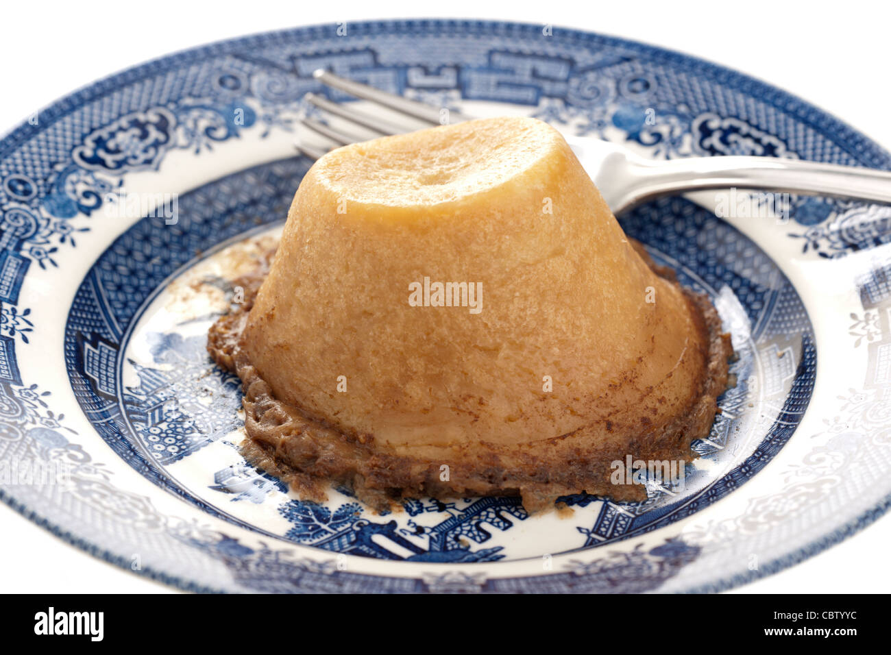 Small microwaved steak and kidney pudding on a plate with fork Stock ...