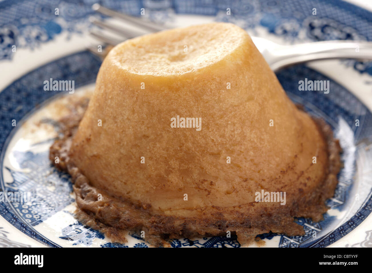 Small microwaved steak and kidney pudding on a plate with fork Stock ...