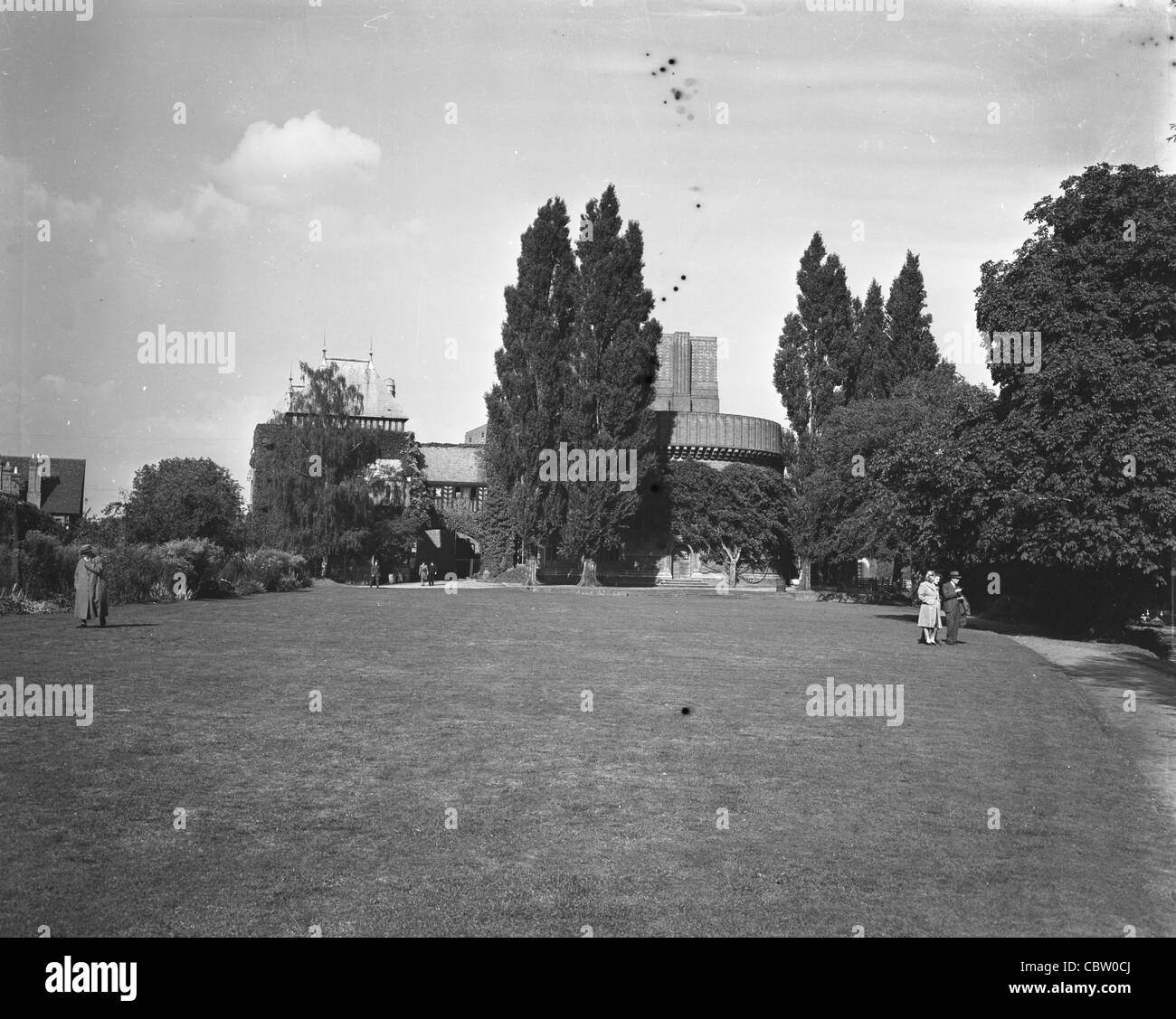 building with grass field Stock Photo - Alamy