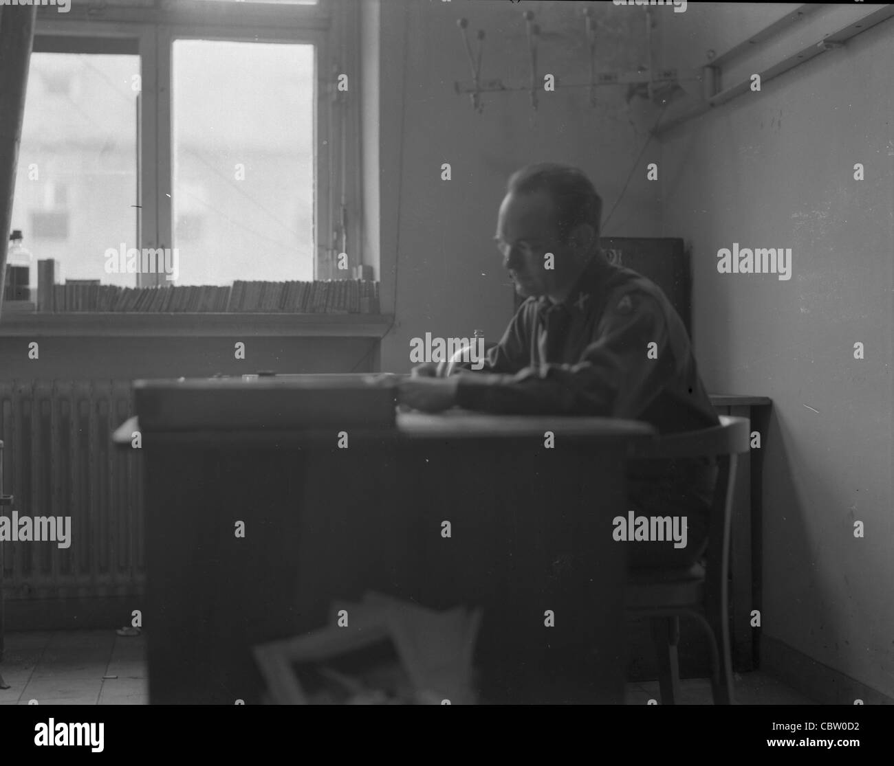 Third army officer sitting at desk writing Stock Photo - Alamy