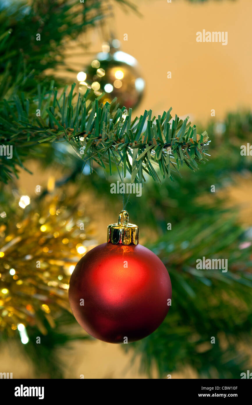 A red bauble hanging from a Christmas tree Stock Photo - Alamy