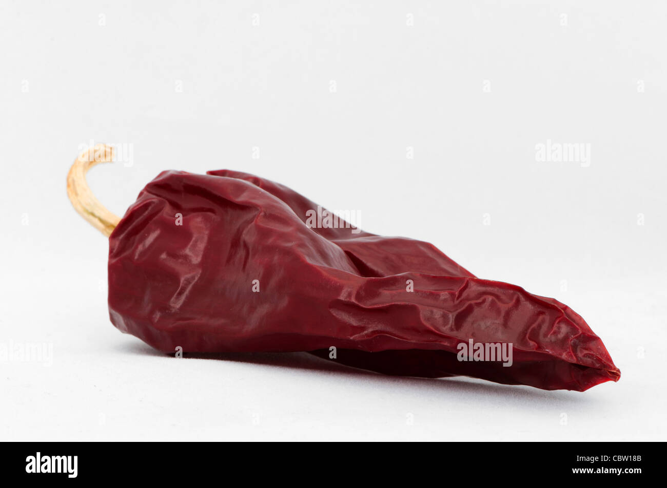 Dried big red pepper. White isolated Stock Photo - Alamy