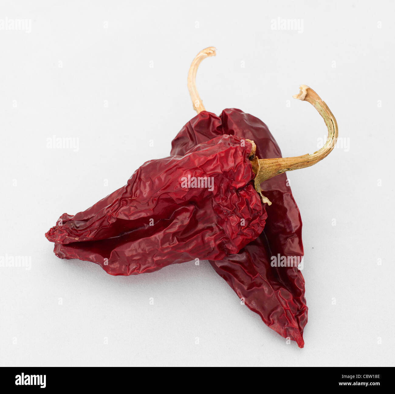 Dried big red peppers. White isolated Stock Photo - Alamy