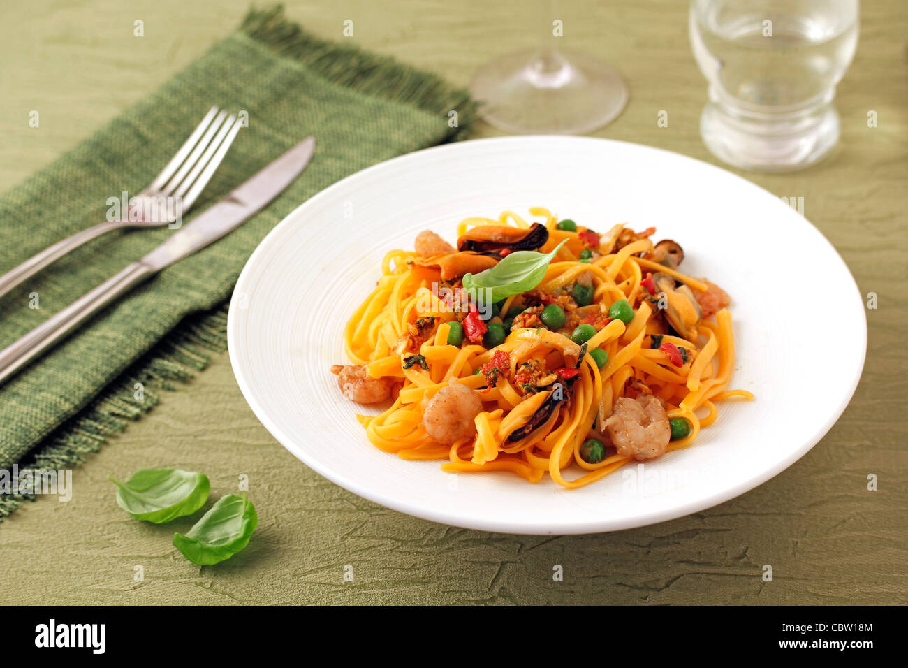 Orange spaghetti with mussels and prawns. Recipe available Stock Photo ...